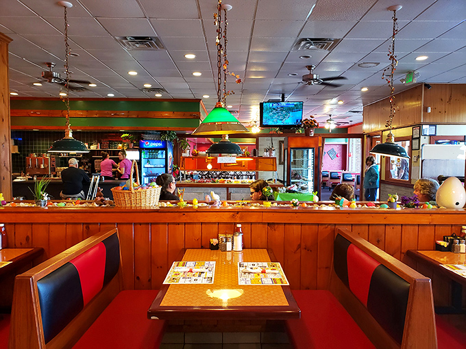 Wood paneling, red booths, and pendant lights create that perfect diner atmosphere where calories don't count and coffee refills are mandatory.