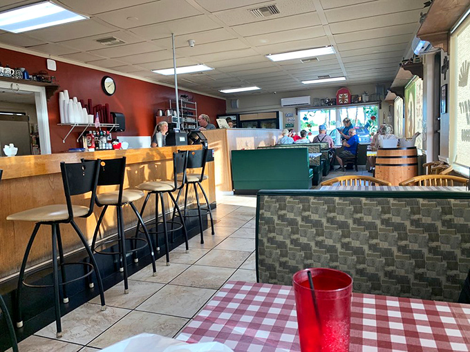 Inside, the classic diner aesthetic welcomes you like an old friend. Red walls, wooden booths, and checkered tablecloths set the stage for comfort food magic.