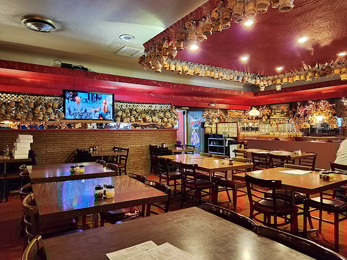 Chianti bottles by the hundreds create a canopy of memories overhead. Each one represents a celebration shared over legendary pizza.