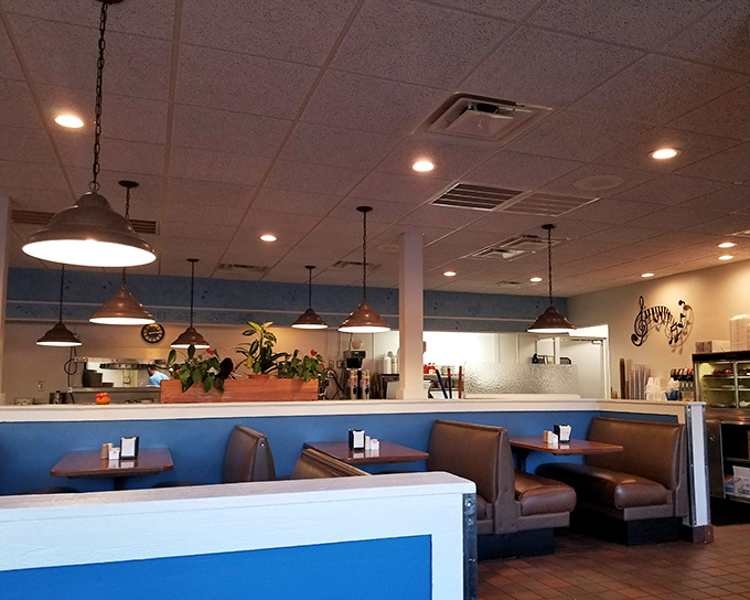Classic diner aesthetics done right&mdash;blue accents, pendant lighting, and comfortable booths where food-induced happiness regularly occurs. 