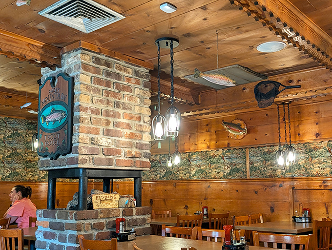 Warm pine paneling and a central brick fireplace create that "grandpa's fishing cabin" ambiance, where every mounted trout on the wall seems to wink knowingly at your excellent dining choice.