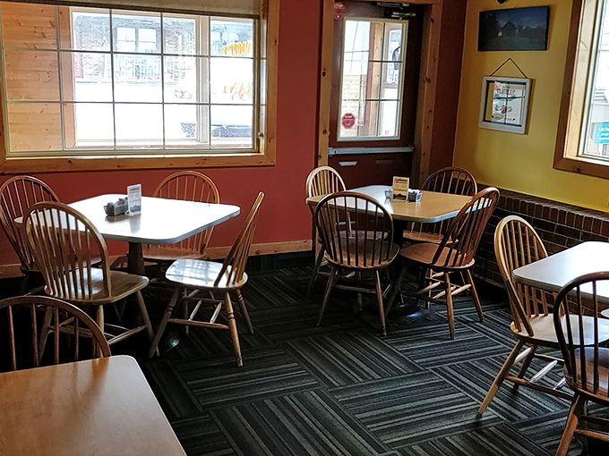 Windsor chairs and warm-colored walls create that "grandma's kitchen" vibe we all crave. No designer needed&mdash;just genuine small-town comfort.
