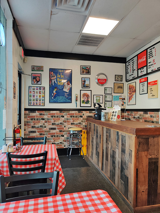 Red checkered tablecloths and brick accents create that timeless pizzeria charm your grandmother would absolutely adore.