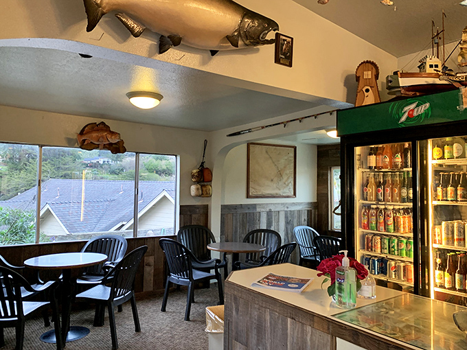 Mounted fish keep watchful eyes over diners while the 7UP cooler hums quietly. Simple tables invite you to focus on what matters – the food.