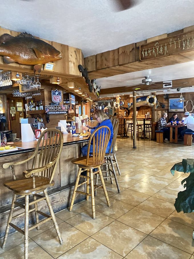 Inside, wooden beams and mounted fish create that authentic "Florida fisherman chic" atmosphere where every nautical decoration tells a story.
