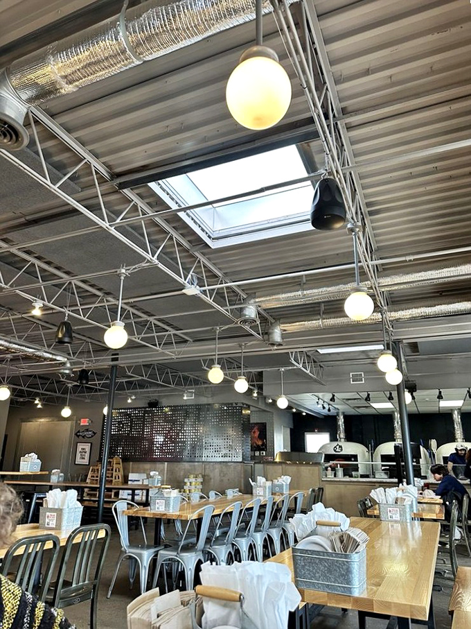Industrial chic meets cozy comfort under these soaring ceilings. The perfect backdrop for pizza-fueled conversations that last for hours.