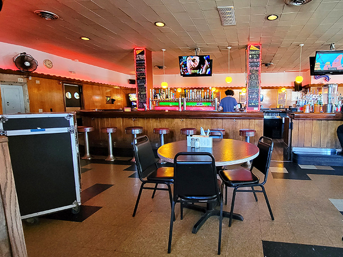 Classic diner vibes with wood paneling and round tables create the perfect backdrop for hot dog adventures. It's like your favorite uncle's basement, if your uncle was a culinary genius.