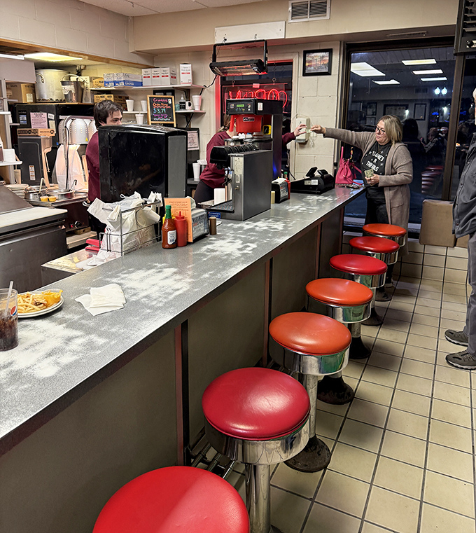 Those cherry-red counter stools aren't just for show—they've supported generations of Missourians waiting for burger perfection.