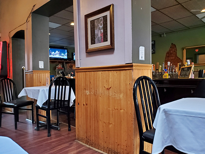 Simple wooden wainscoting and white tablecloths create that perfect sweet spot between "nice enough for date night" and "comfortable enough to lick your fingers."