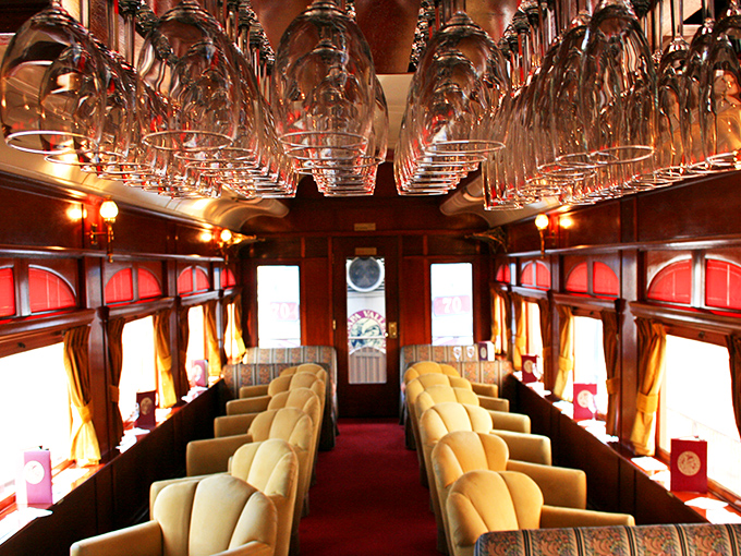 Wine glasses hang like crystal stalactites, promising liquid treasures to come. This isn't just storage&mdash;it's an upside-down cathedral of future pleasure.