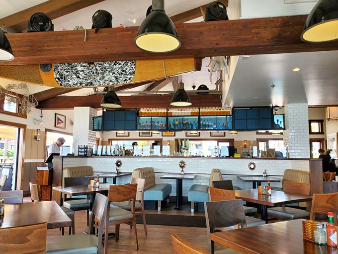 Exposed wooden beams and pendant lighting create the perfect backdrop for seafood storytelling, where every table feels like the captain's table.