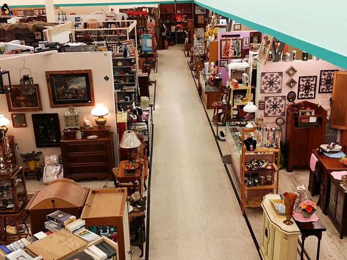 Long, pristine aisles stretch into the distance, flanked by vendor booths packed with treasures from every era. The journey begins here.