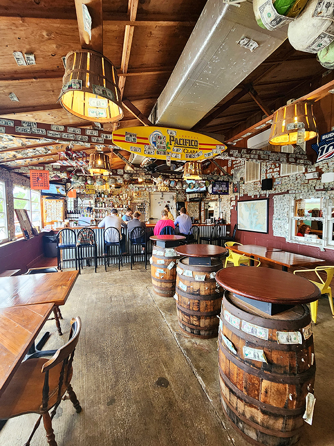 Dollar bills wallpaper the ceiling while barrel tables invite you to settle in&mdash;this isn't just decor, it's decades of delicious memories.
