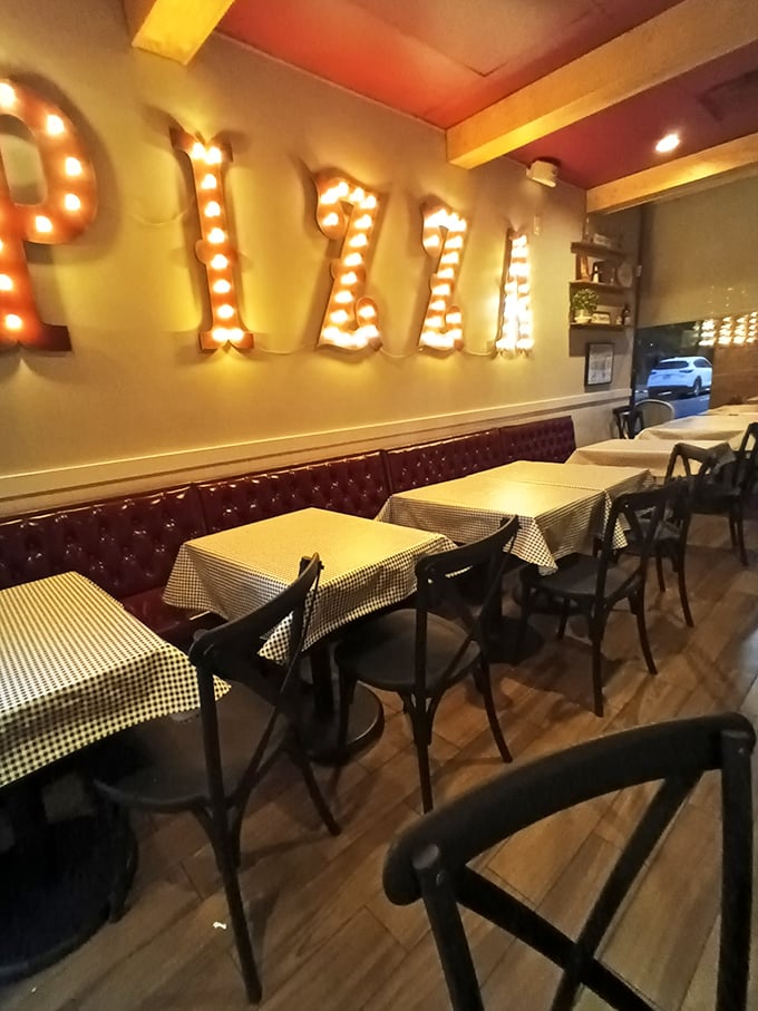 The illuminated "PIZZA" sign isn't just decoration&mdash;it's more like a marquee announcing the main attraction in this cozy Italian theater of deliciousness.