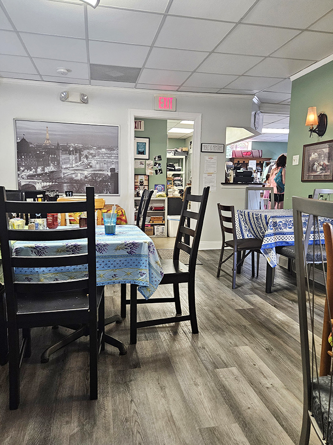 Inside, Parisian vibes meet Main Line charm with mismatched tables, patterned tablecloths, and that striking black-and-white photo of the City of Light.