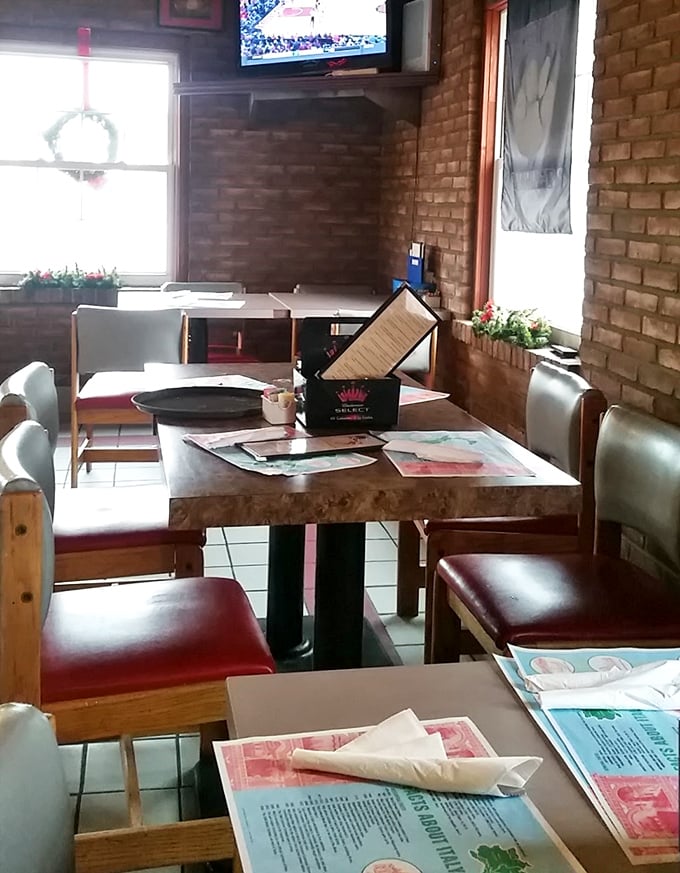Red chairs, wooden tables, and exposed brick walls create that perfect "nobody's trying too hard" atmosphere where great food always seems to happen.