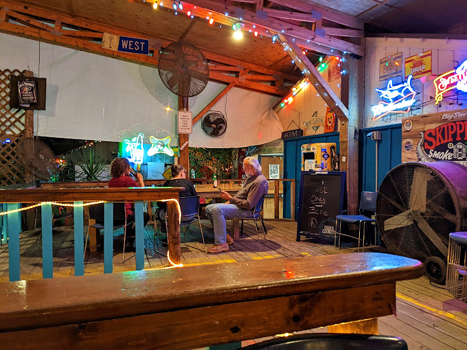 String lights and mismatched furniture create that "come as you are" vibe where conversations flow as freely as the drinks.