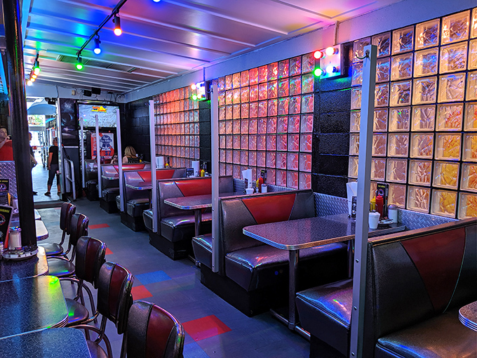 Step inside and you're transported to a retro-futuristic universe where glass block dividers shimmer under colorful string lights, making even waiting for your food an otherworldly experience.