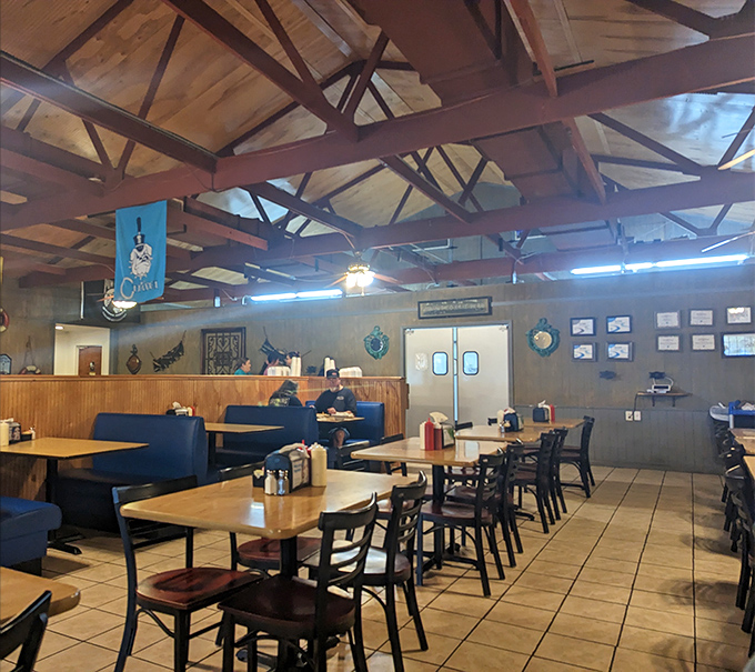 Wooden beams stretch overhead like ship timbers while nautical touches remind you that yes, seafood this good deserves a proper maritime setting.