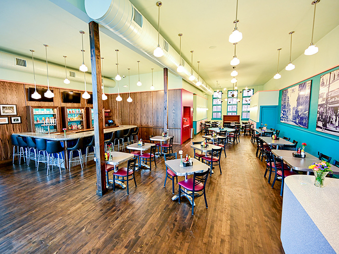 Polished wood floors, pendant lights, and turquoise walls create the perfect backdrop for life's most important decisions: pancakes or French toast?