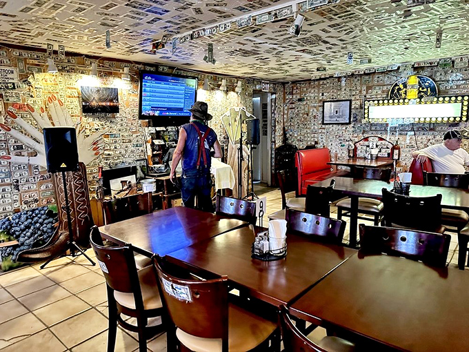 Dollar bills wallpaper every surface inside, creating a living guest book where thousands of visitors have literally left their mark.