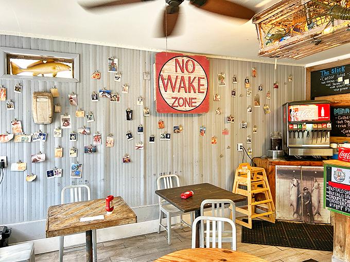 The "NO WAKE ZONE" sign perfectly captures the laid-back vibe where time slows down but your appetite kicks into high gear.