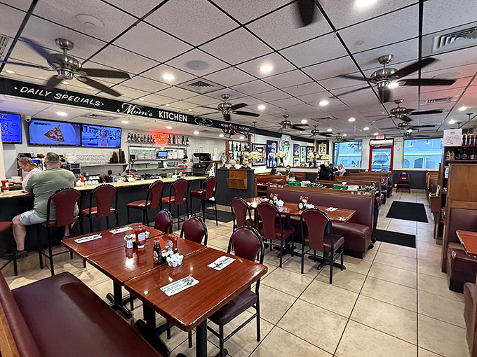 Classic diner charm meets modern comfort inside Mom's Kitchen, where ceiling fans lazily spin above the breakfast symphony below.