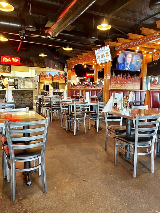 Industrial chic meets barbecue comfort in Phil's dining room, where exposed ductwork and wooden beams create the perfect backdrop for sauce-stained conversations.