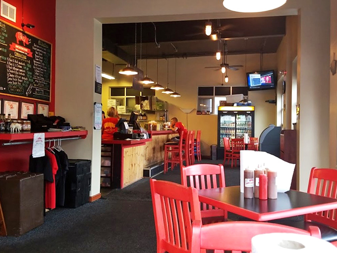 Red chairs pop against neutral walls in this no-nonsense dining room where the focus is squarely where it should be&mdash;on the smoky treasures coming from the kitchen.