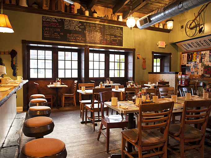 Wooden tables, exposed brick, and natural light create the perfect backdrop for morning conversations that flow as freely as the coffee refills.