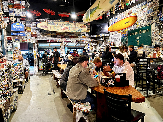 License plates from every corner of America line the walls while surfboards hang overhead. Organized chaos that somehow feels exactly right.