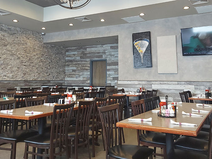 Modern meets classic in this thoughtfully renovated dining room. The stone accent walls and warm lighting create an atmosphere that says "stay awhile."
