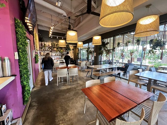 Step inside to a symphony of wicker lampshades, purple accent walls, and thriving plants. The atmosphere strikes that perfect balance between "Instagram-worthy" and "I can actually relax here."