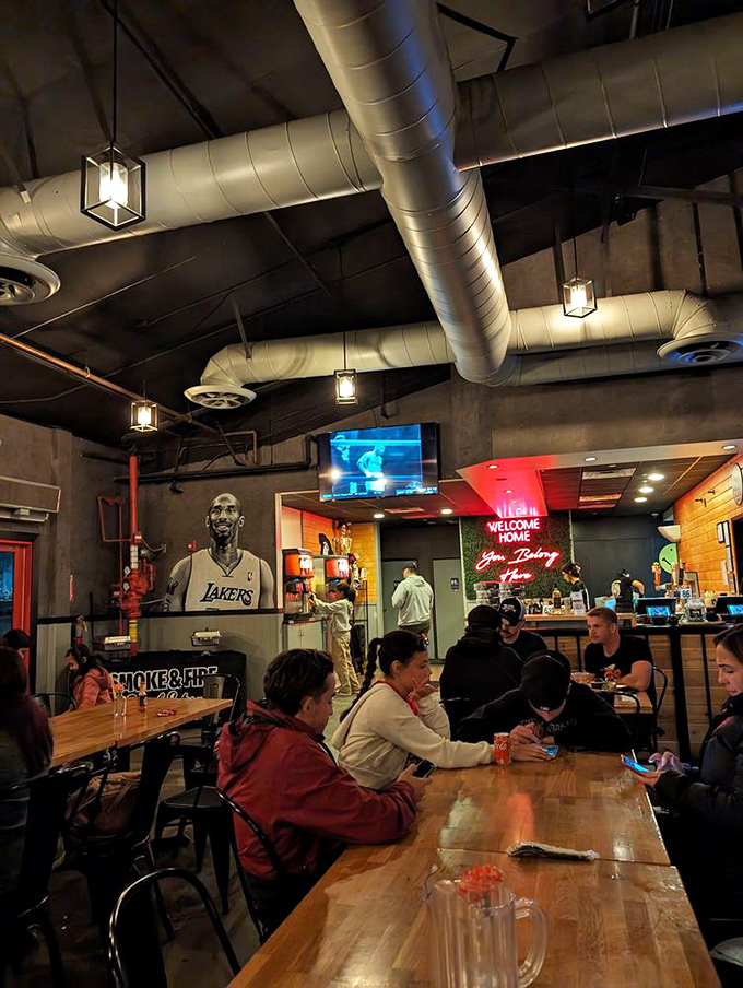 Industrial chic meets BBQ comfort under exposed ductwork and pendant lighting, while Kobe watches over diners from his wall mural.