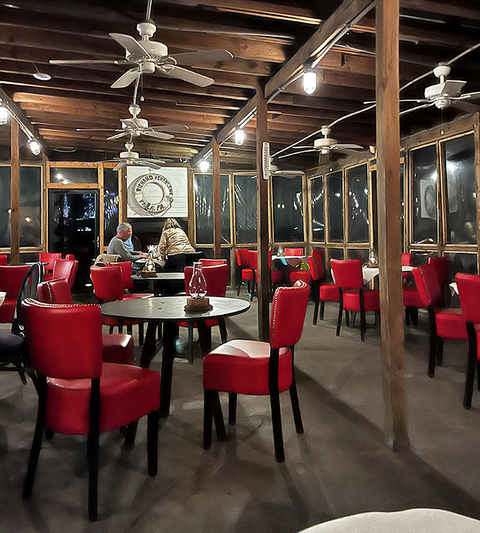 Red vinyl chairs and exposed wooden beams create a maritime charm that's refreshingly authentic. No pretense, just good vibes and great food.