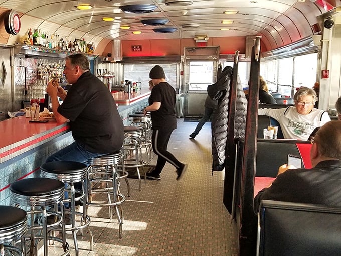 Inside, the classic diner car experience comes alive with curved ceilings, chrome details, and the unmistakable buzz of breakfast conversations.