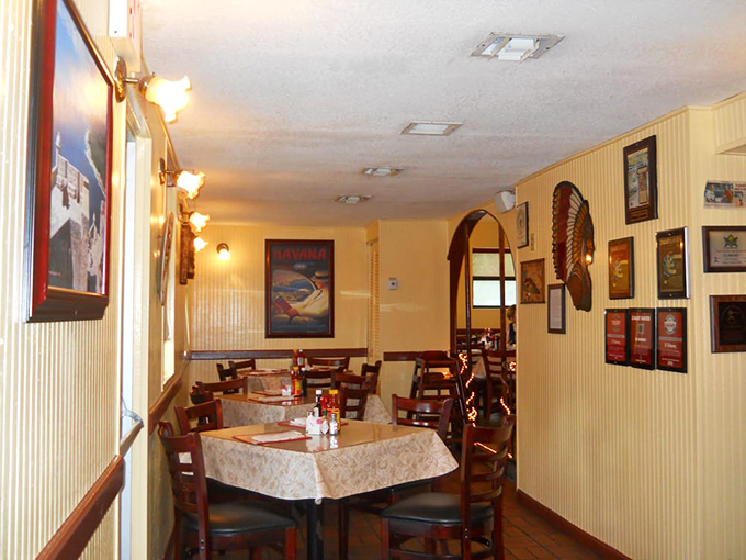 Yellow-striped walls adorned with Cuban memorabilia create the perfect backdrop for the food drama about to unfold on your plate.