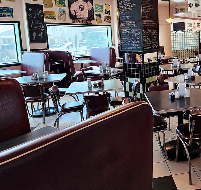 Inside, burgundy vinyl booths and chrome-trimmed tables create that perfect nostalgic atmosphere where conversations flow as freely as the coffee.