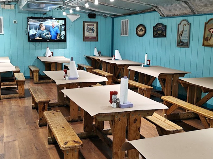 Aqua blue walls and sturdy wooden tables create the perfect no-nonsense backdrop for the serious business of crab demolition.