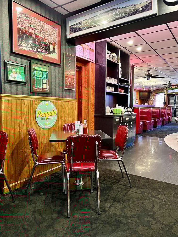 Cherry-red vinyl booths and wood paneling create that perfect time-capsule vibe where comfort and nostalgia share the same table.