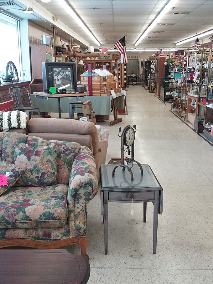 That floral couch has seen some conversations! Nestled between vintage furniture and American flags, it waits patiently for its second act in someone's living room.