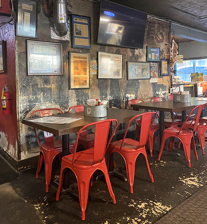 The weathered walls tell stories of barbecue glory while those bright red chairs pop like exclamation points in a meat lover's manifesto.