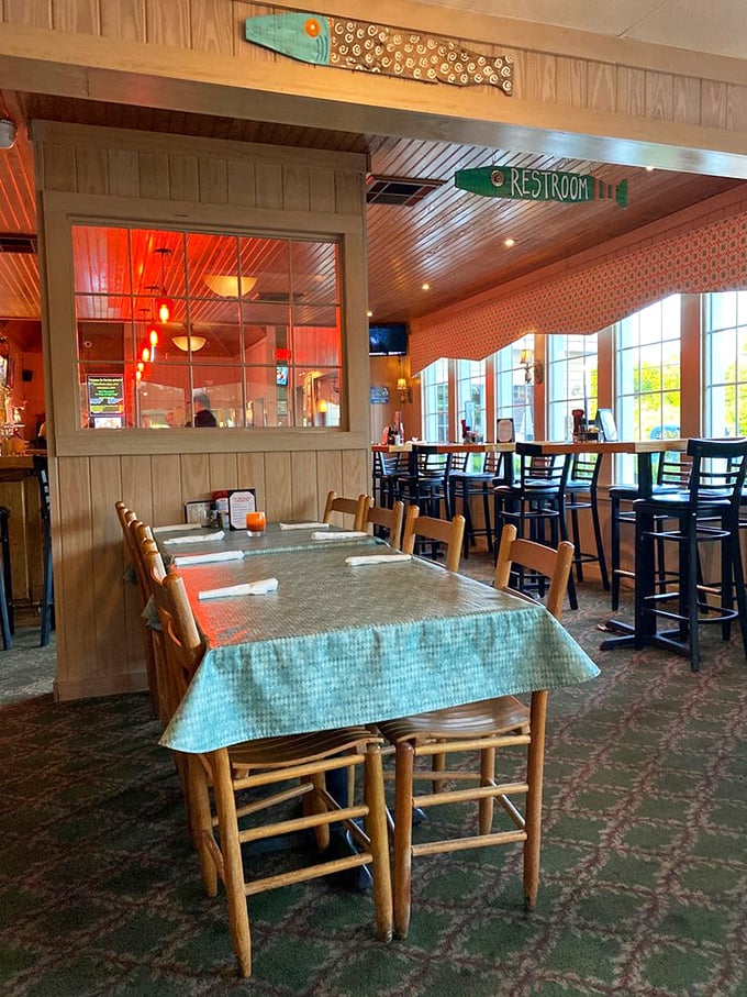 Simple wooden chairs and aqua tablecloths create that rare, unpretentious atmosphere where memorable meals happen without Instagram-worthy design budgets.