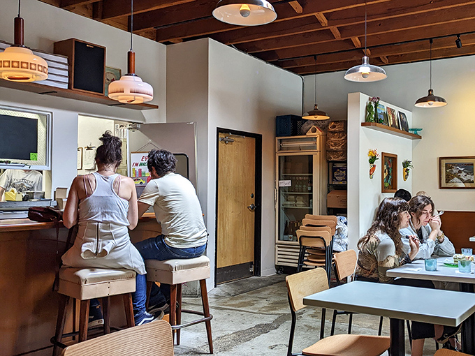 Mid-century modern meets culinary magic in this cozy interior where every seat feels like you've scored the best table in town.