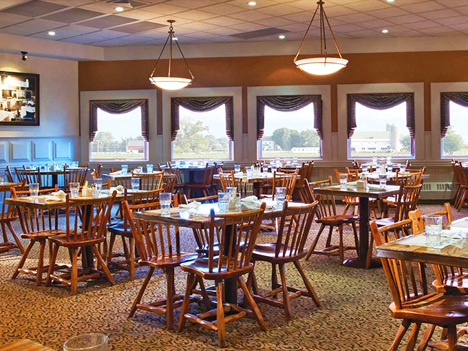 Classic wooden chairs and warm lighting create the perfect setting for serious comfort food conversations.