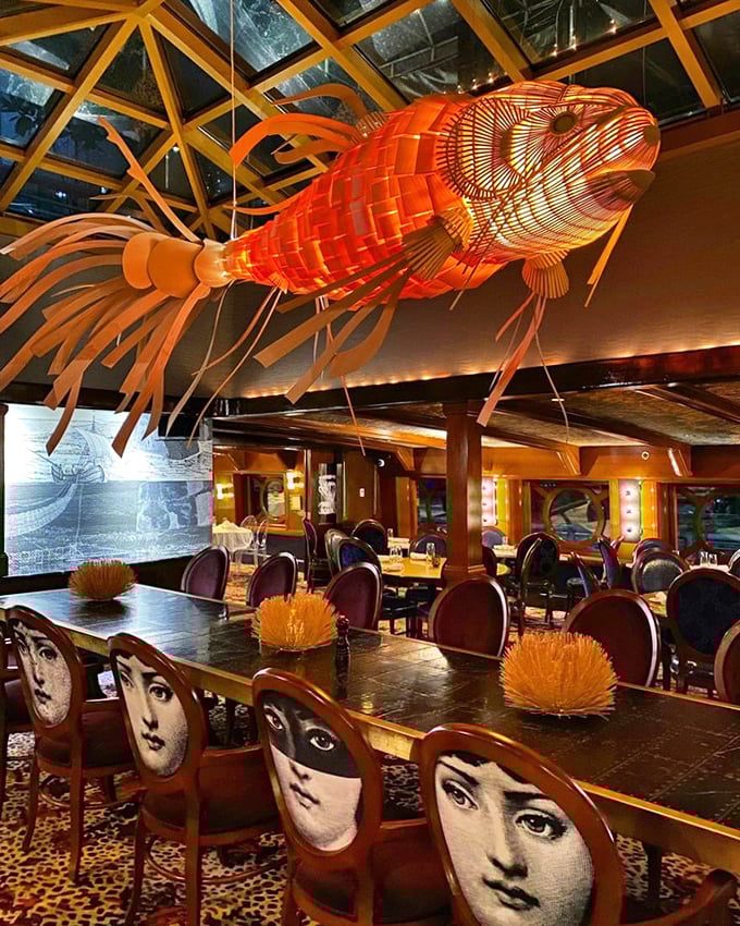 Dining under an illuminated orange fish installation while surrounded by artistic chairs isn't just dinner&mdash;it's theater. The Moshulu's interior design philosophy clearly states: "ordinary belongs elsewhere."