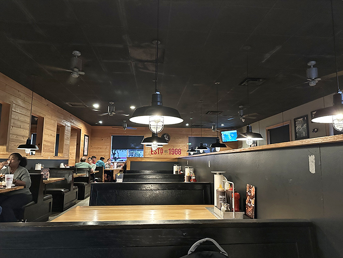Inside, the warm wood paneling and industrial lighting create that perfect "come as you are" atmosphere where sauce on your shirt is a badge of honor.