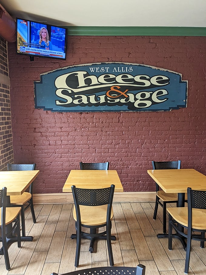Inside, the rustic brick walls and vintage signage create the perfect backdrop for serious cheese contemplation and sausage appreciation.