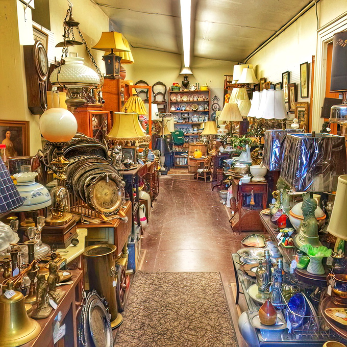 Where time stands still but treasures abound. This narrow passage between decades of collectibles feels like walking through history's most fascinating garage sale.