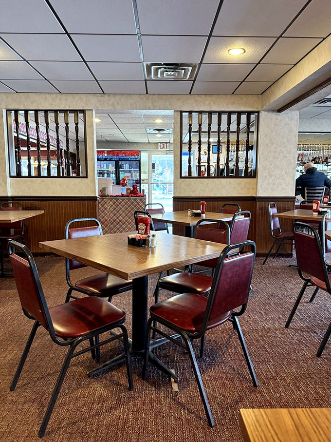Red vinyl chairs and wooden dividers create that perfect diner atmosphere where conversations flow as freely as the coffee.